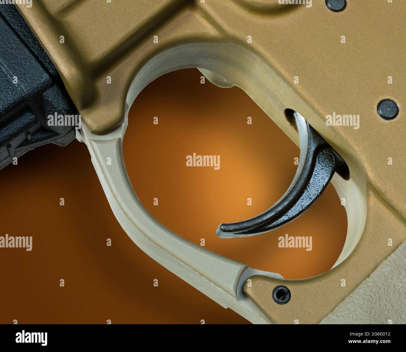 Trigger from a copper colored assault rifle on brown with a dropshadow ...