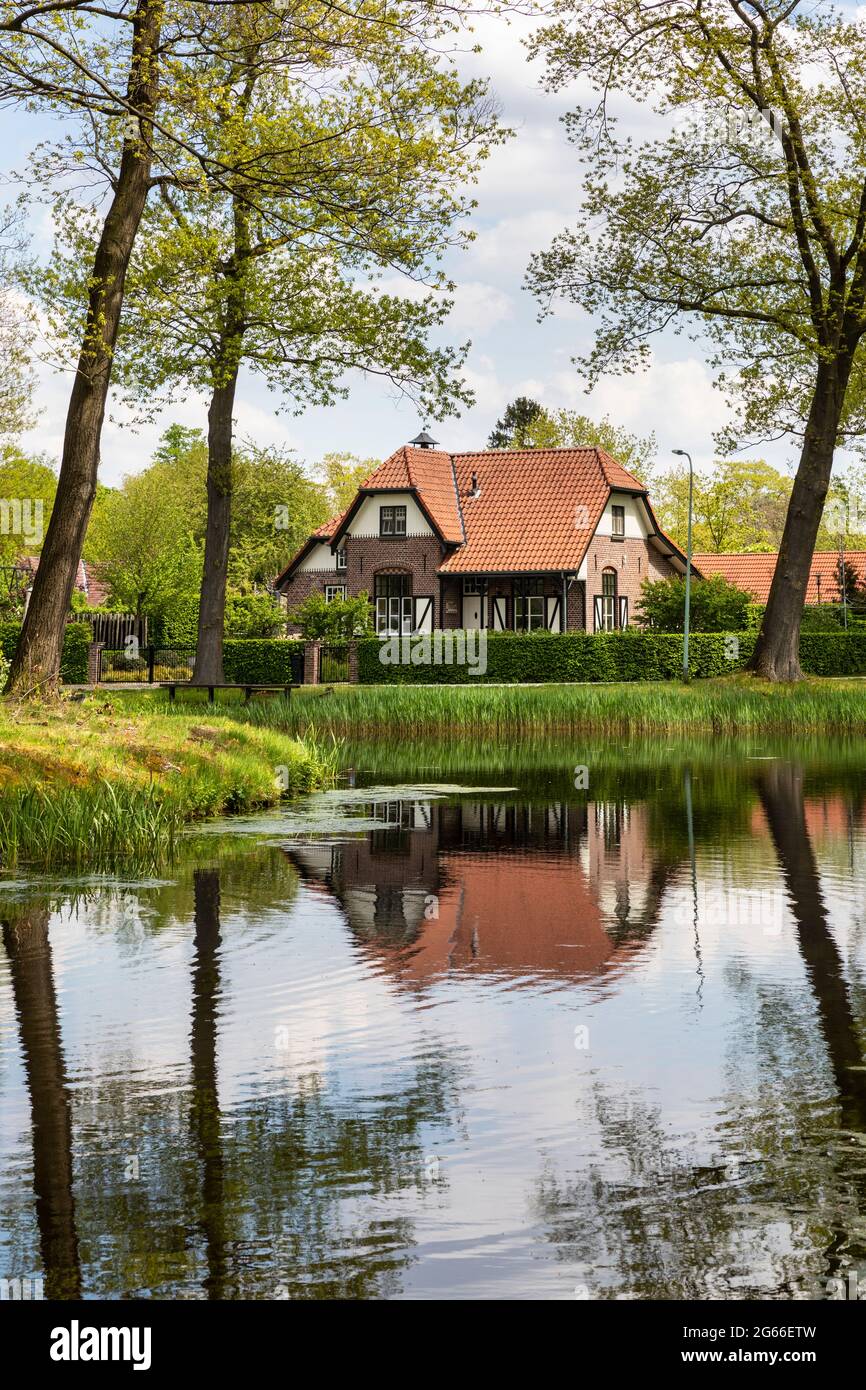 Typical dutch authentic old house near the river with reflections in ...