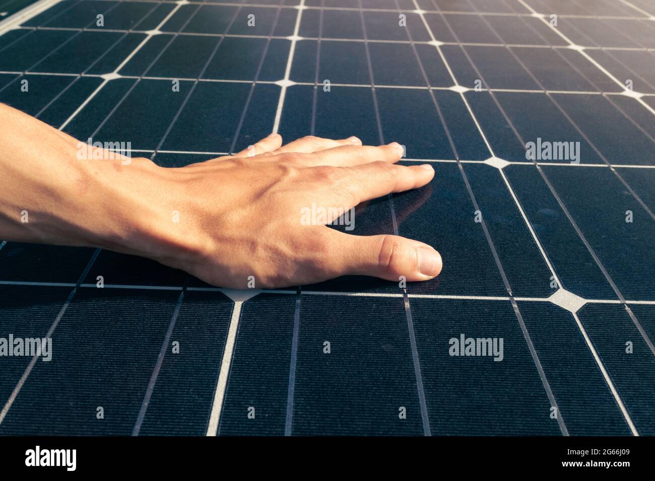 Man hand touching solar panels on sun Stock Photo - Alamy