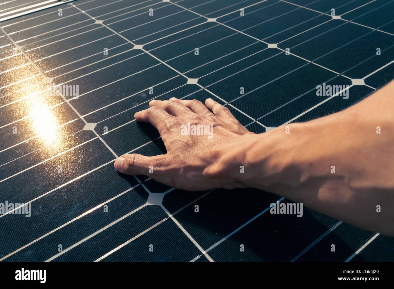 Hand on solar panel hi-res stock photography and images - Alamy
