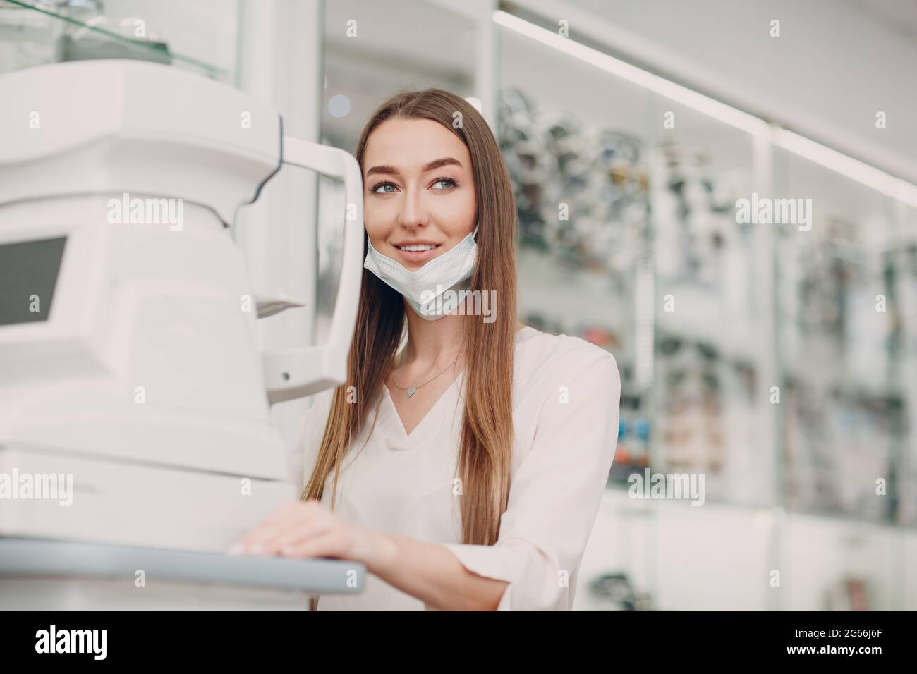 A woman doctor and patient doing opthalmology refractometer check ...