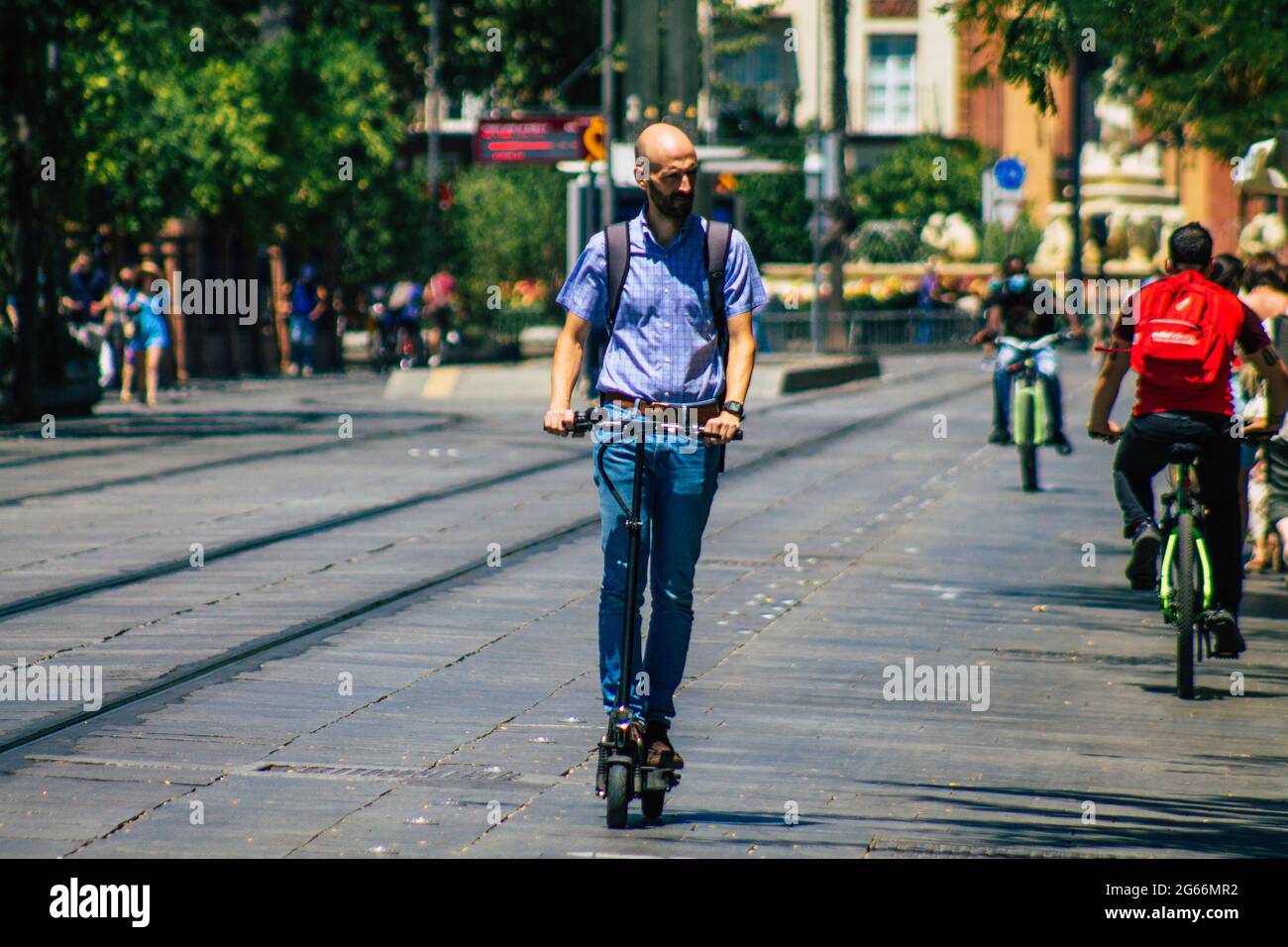 Seville Spain July 02, 2021 People rolling with an electric scooter in ...