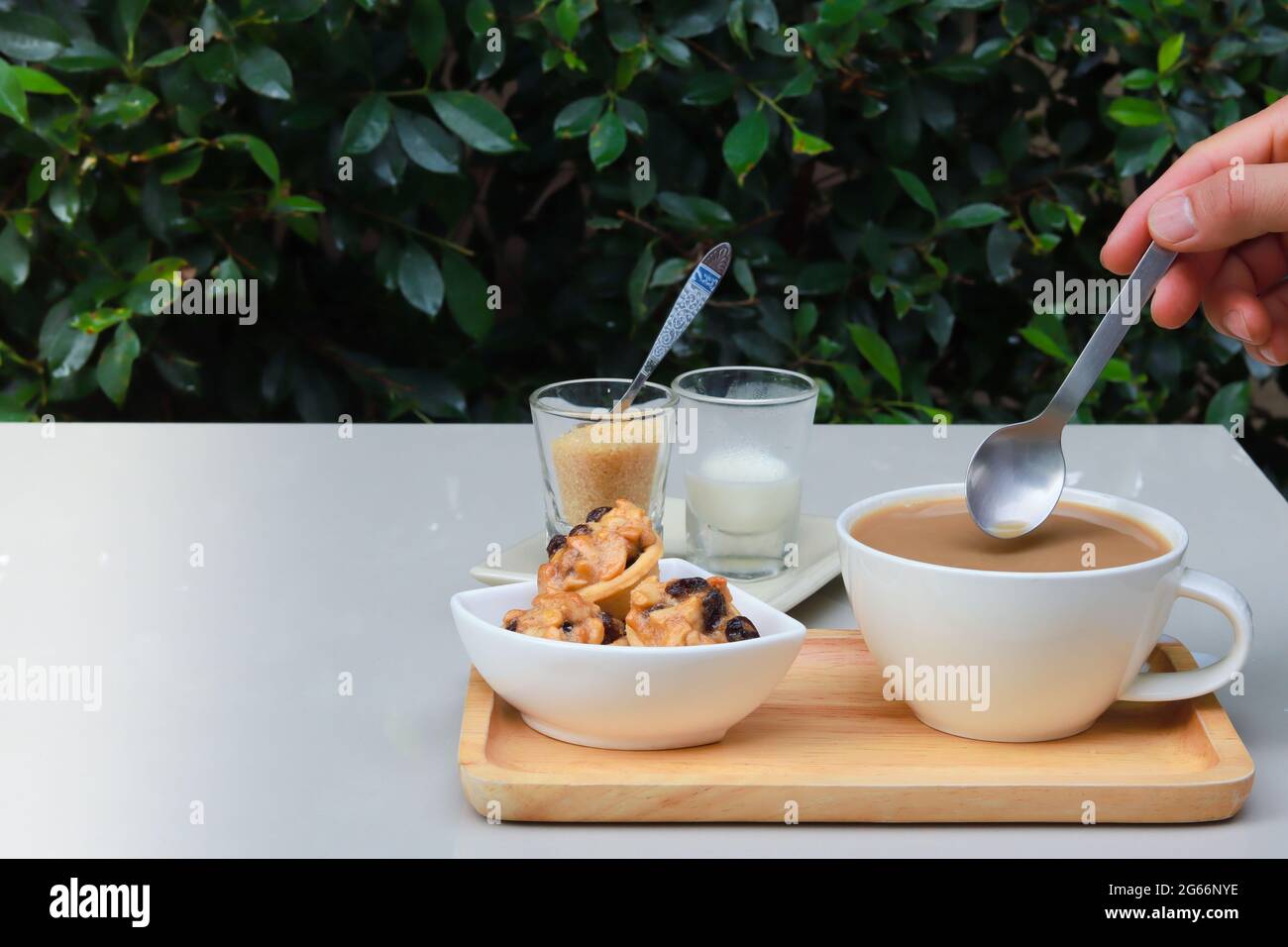 Hands stir coffee in green hi-res stock photography and images - Alamy