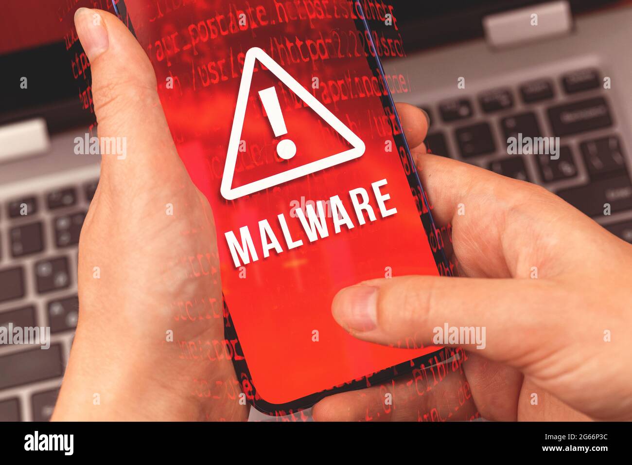 Malware concept with person using smartphone, background of the laptop ...