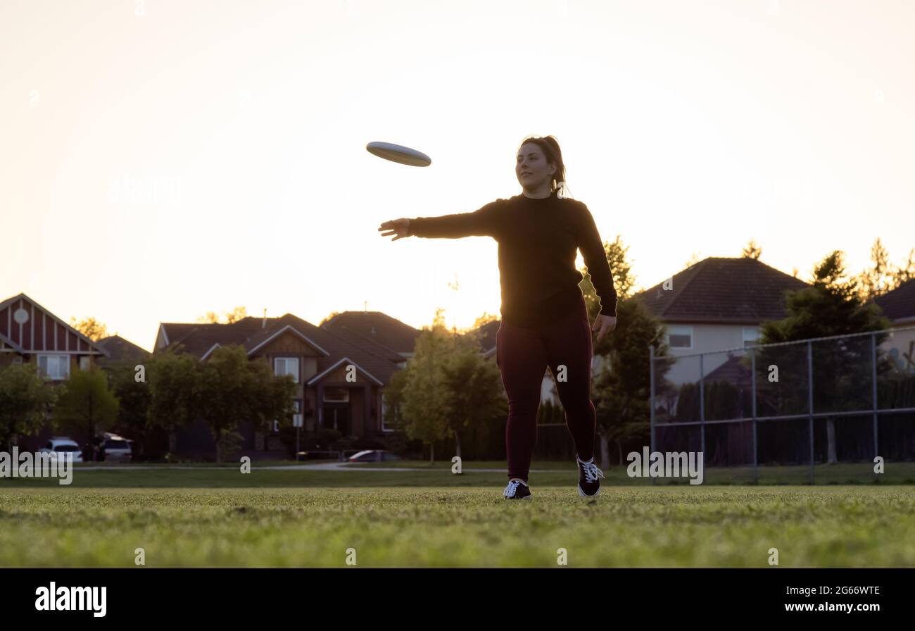 White Caucasian Adult Girl Playing Frisbee in the Green Field Stock ...