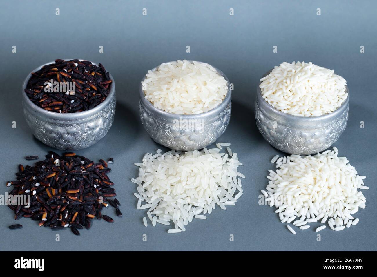 Three types of rice in a silver container. On a gray background and ...