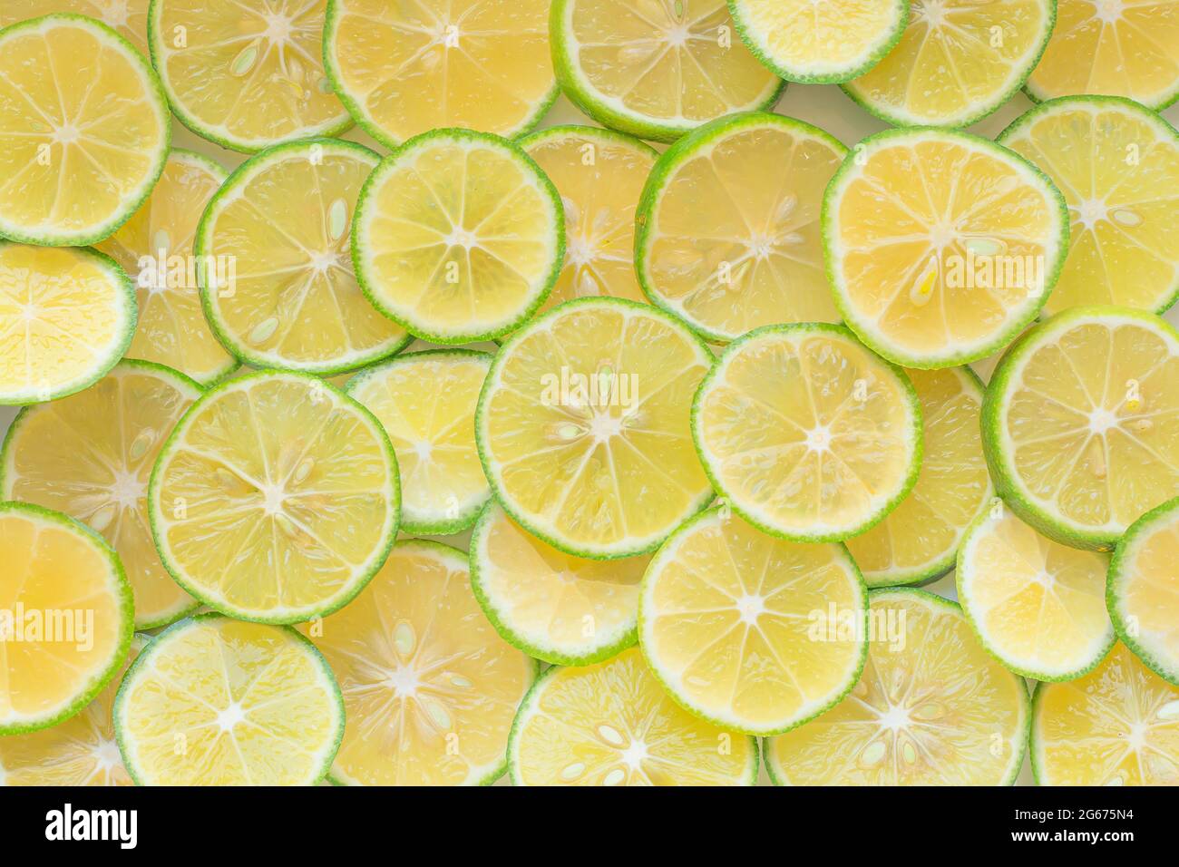 Food background. Sliced lemons neatly laid out on a white background ...