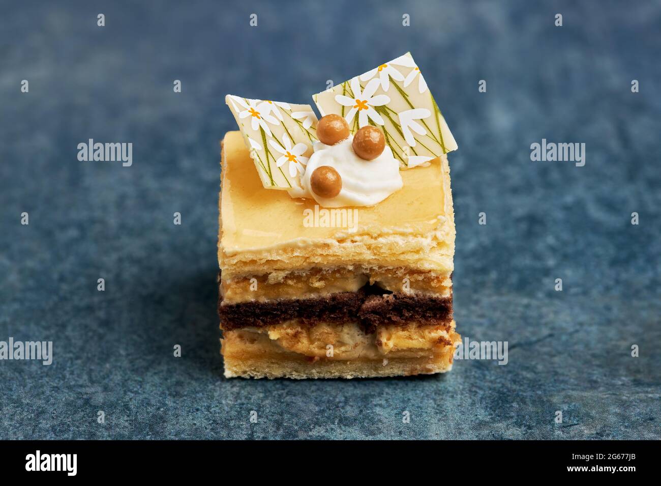 Small portion of a cream, chocolate and sponge cake Stock Photo - Alamy