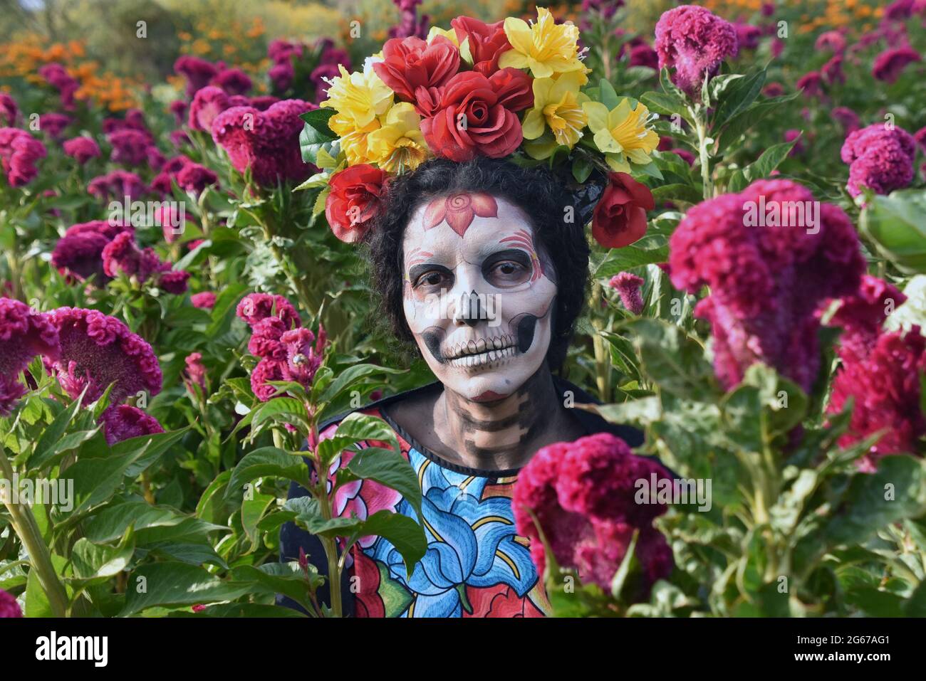 A woman dressed as Catrina, a famous Day of the Dead figure, poses in a ...