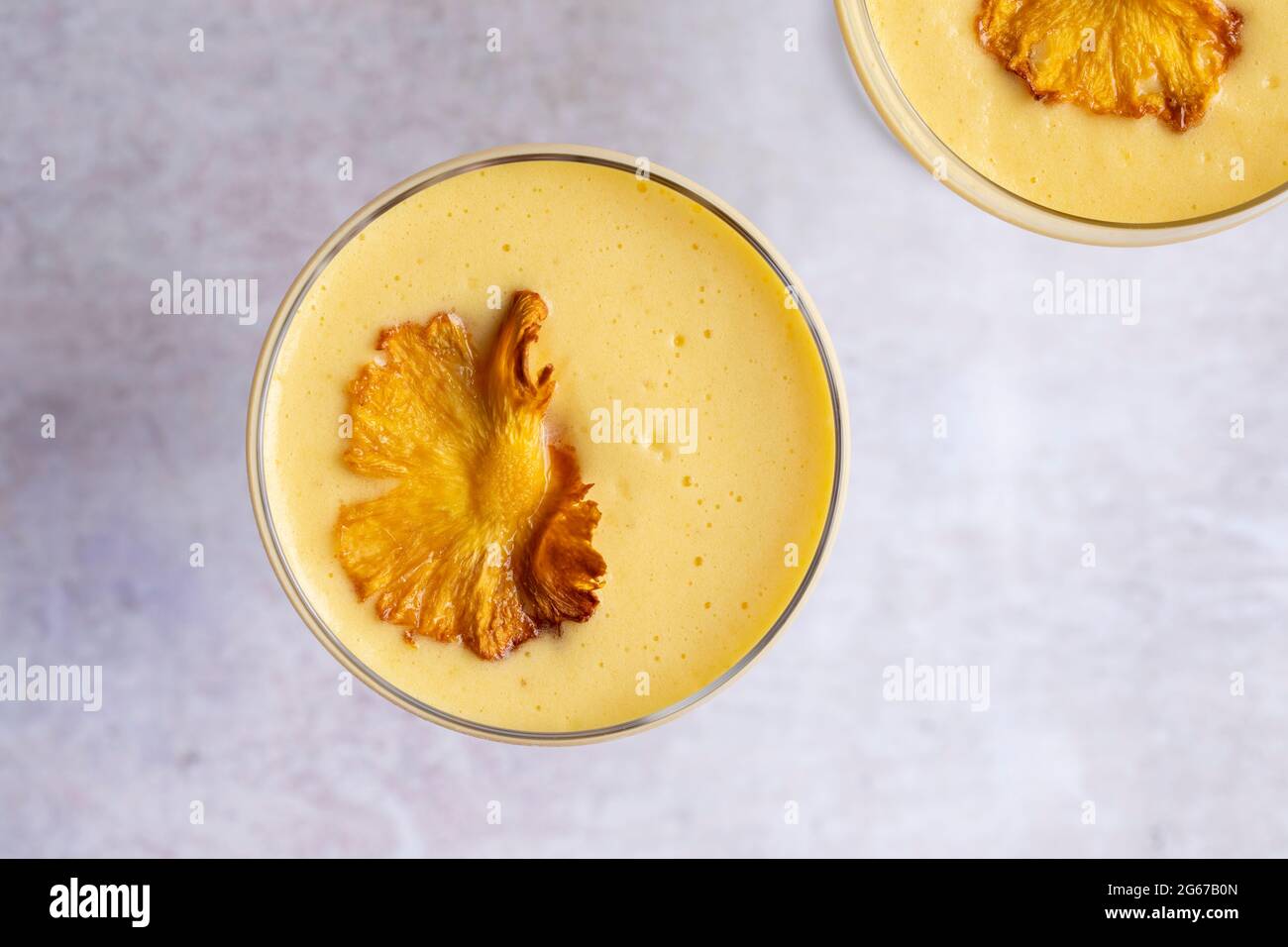 Pineapple cocktail with crispy pineapple garnish Stock Photo - Alamy