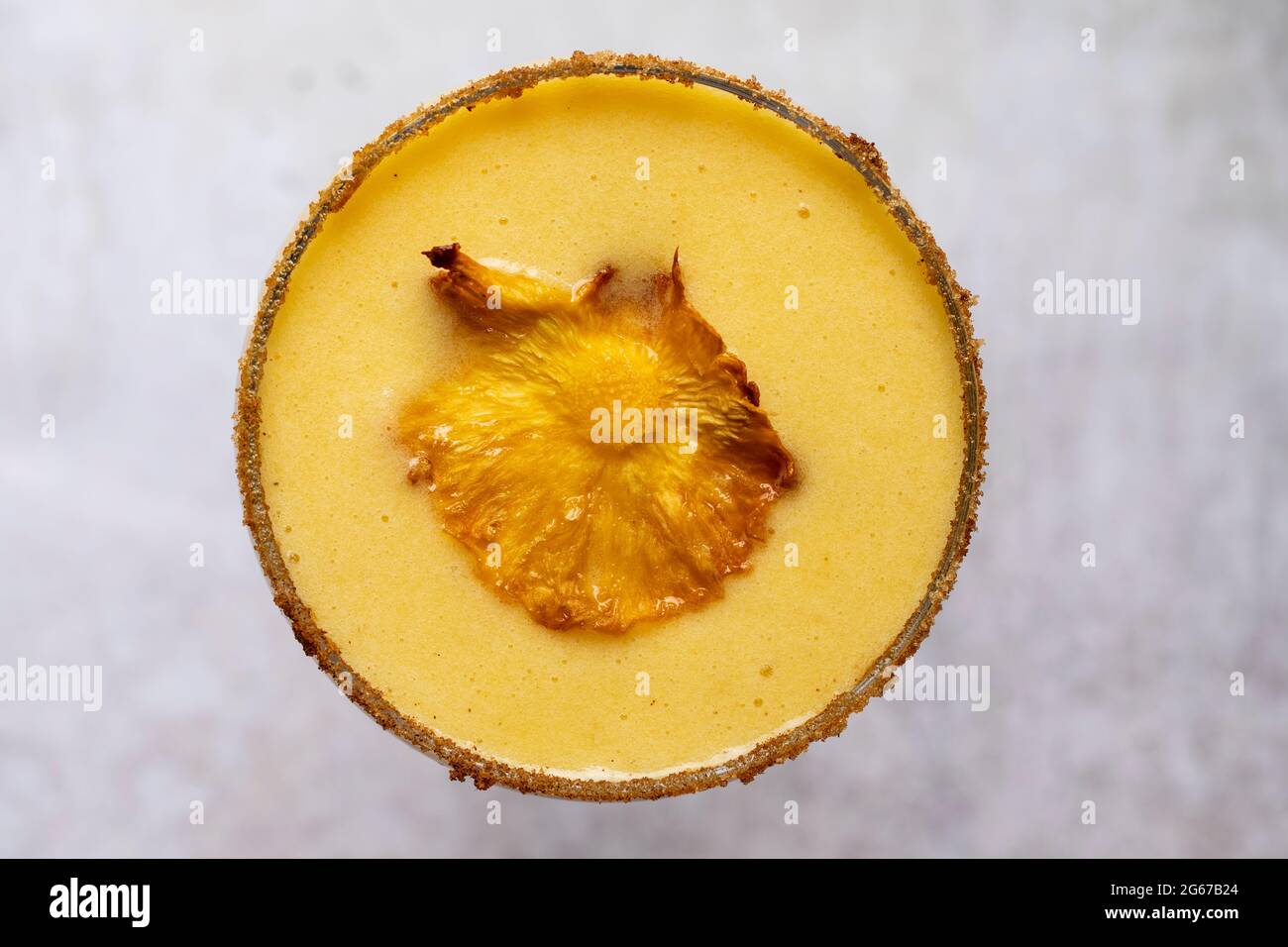 Pineapple cocktail with crispy pineapple garnish Stock Photo - Alamy