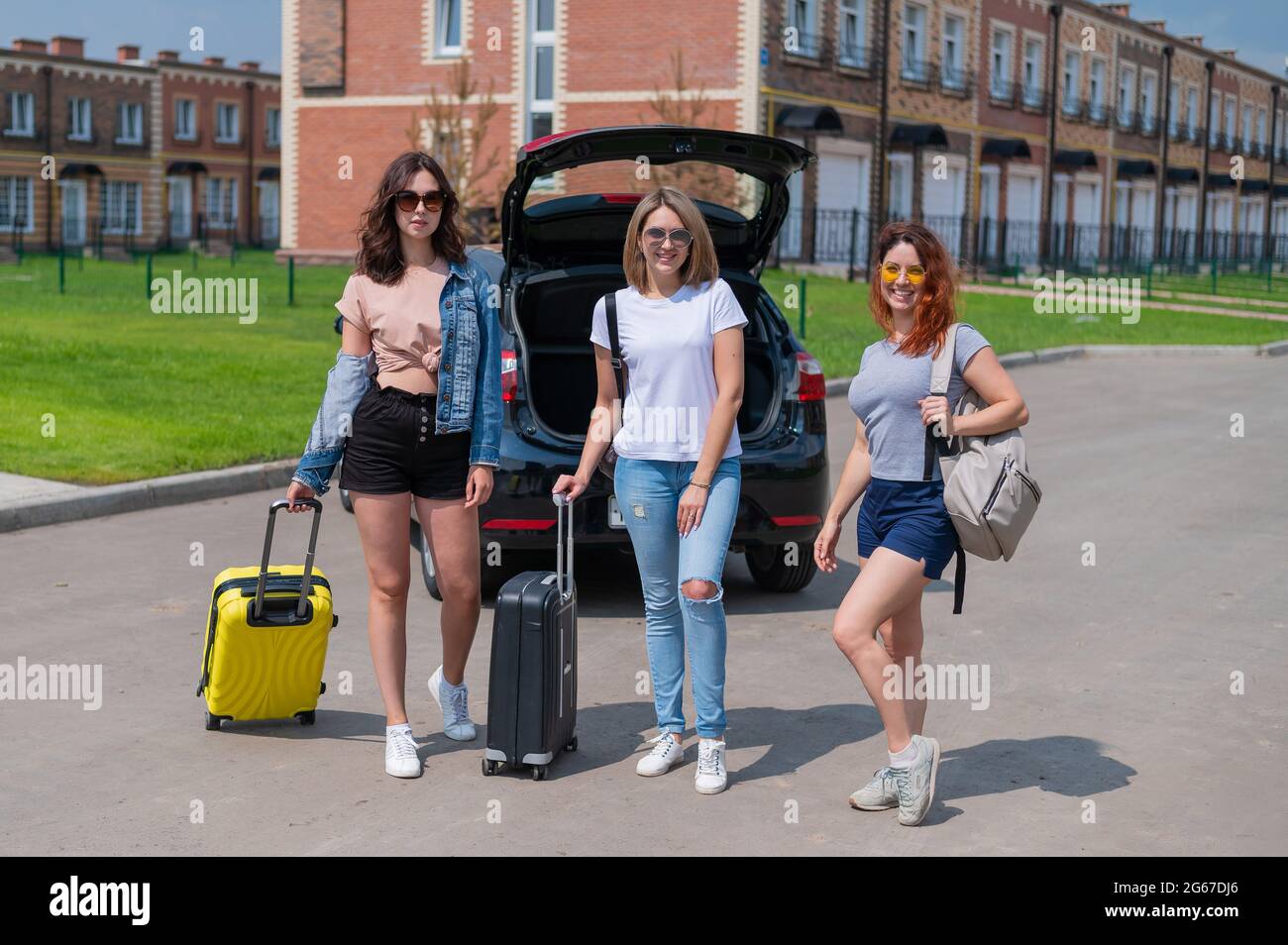 Three friends go on a trip by car Stock Photo - Alamy