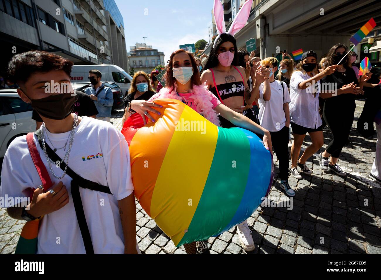 Participants hold a big color herat during the parade. A group of ...
