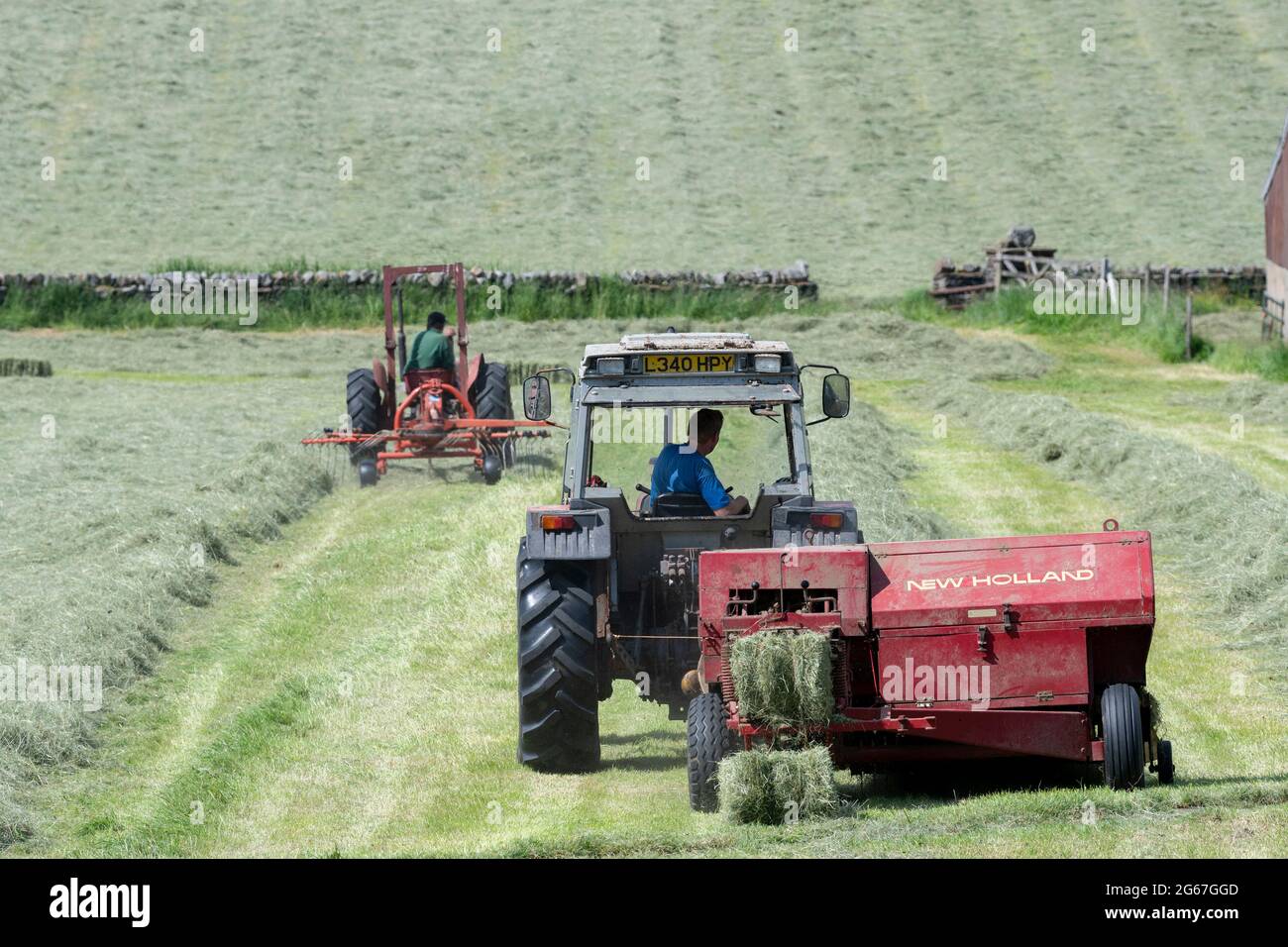 Baling small bales of Hay with a New Holland baler and a Massey ...