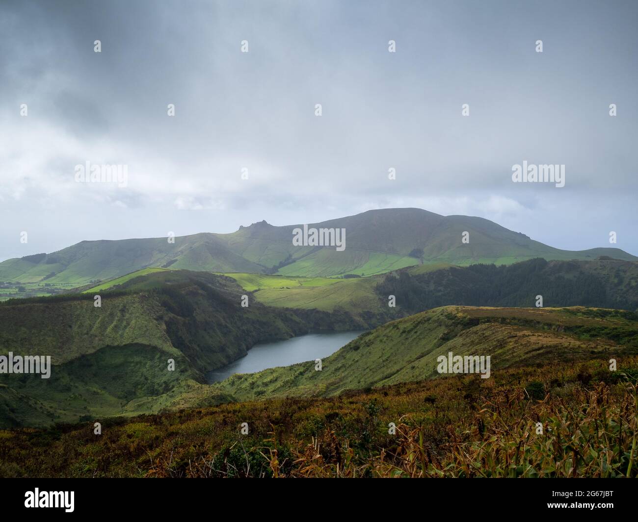 Caldeira Funda lake between the mountains of Flores Island Stock Photo ...