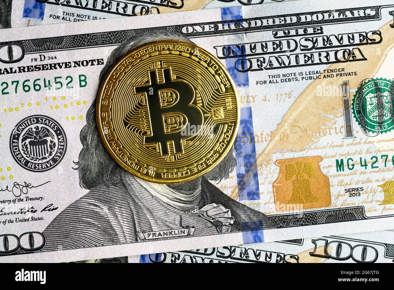 Bitcoin vs US dollar, gold bit coins on 100 dollar bill. Digital crypto ...