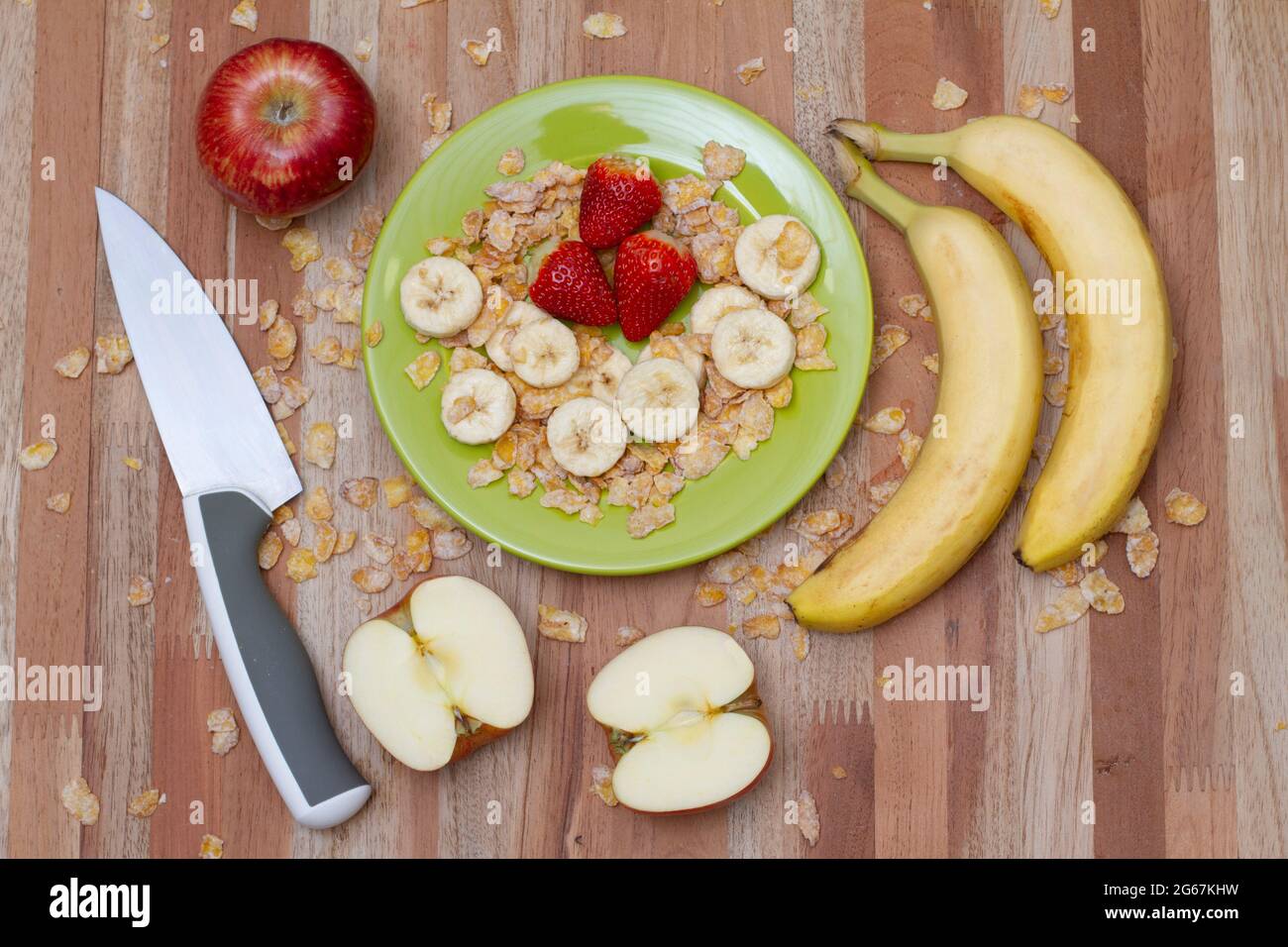 Red apple, sliced banana, strawberry berries and cereals Stock Photo ...