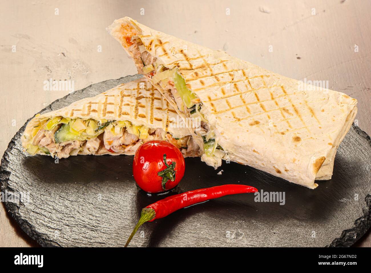 Tasty shawarma with meat, sauce and vegetables Stock Photo - Alamy