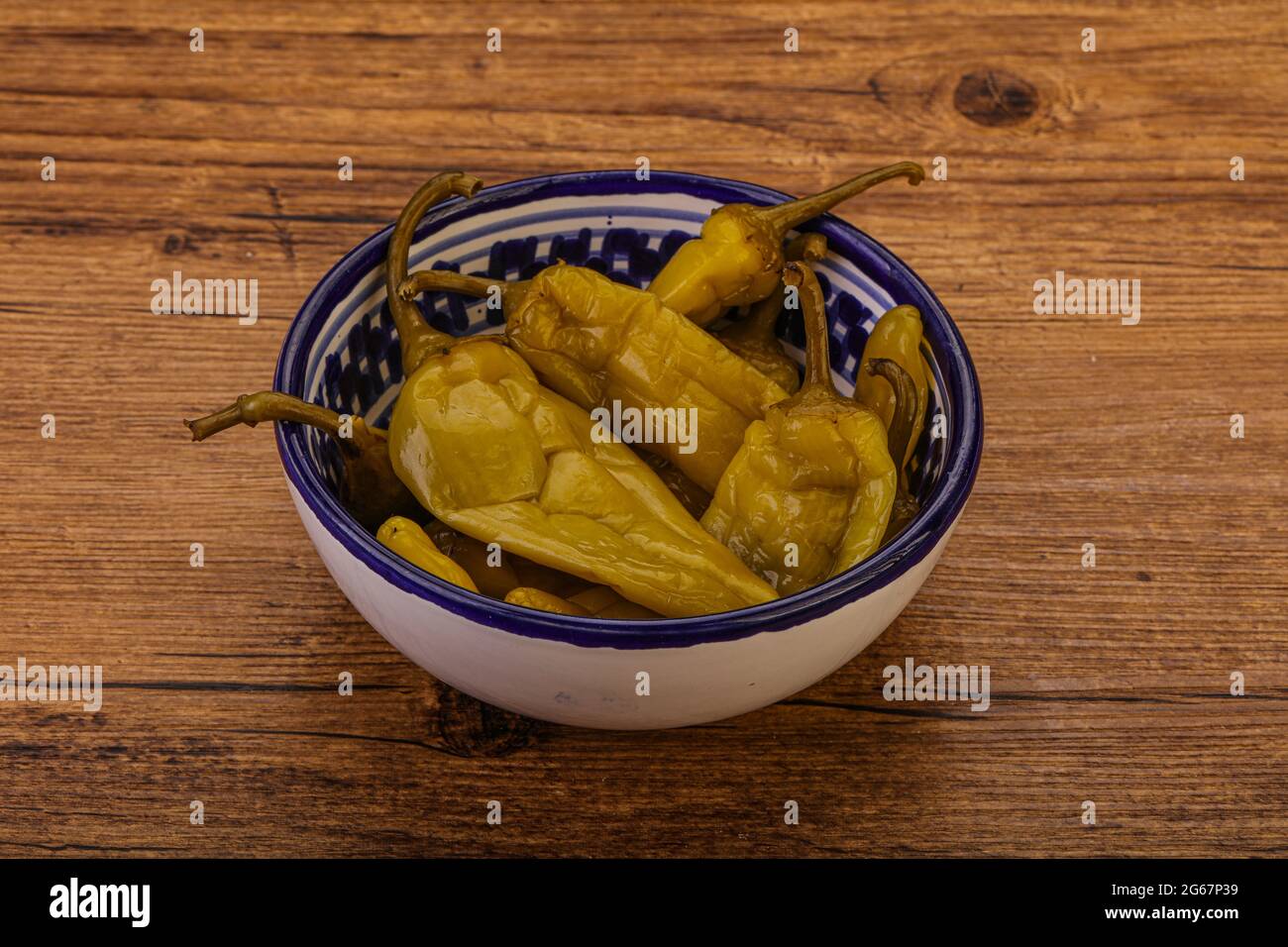 Marinated spicy and hot green pepper in the bowl Stock Photo - Alamy