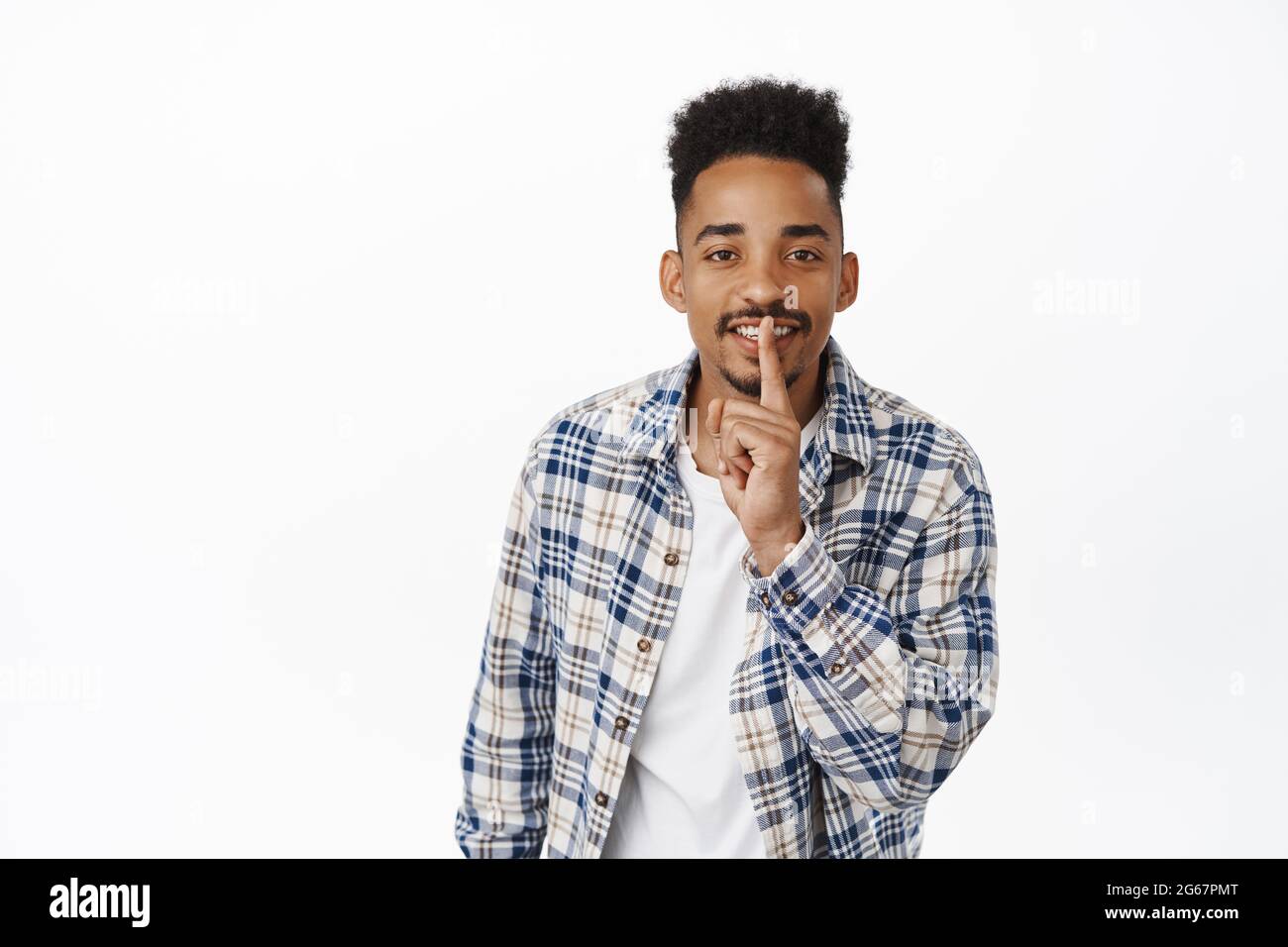 Dont tell anyone. Handsome smiling african american man prepare ...