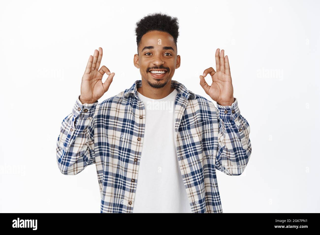 Image of smiling african american guy 20s showing okay, OK zero gesture ...