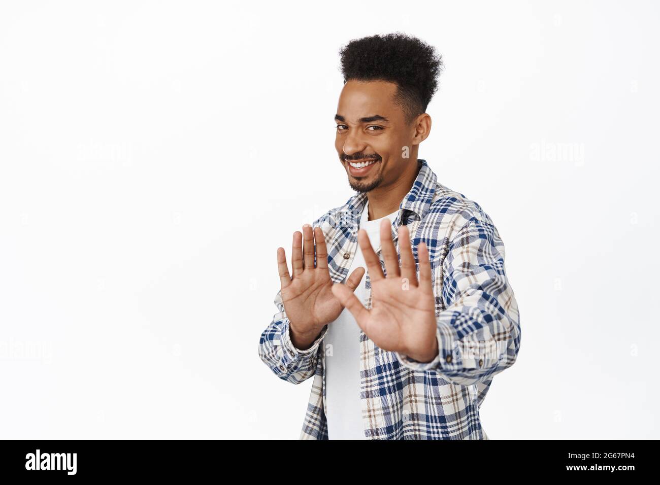 Smiling african american guy refusing politely, look awkward and ...