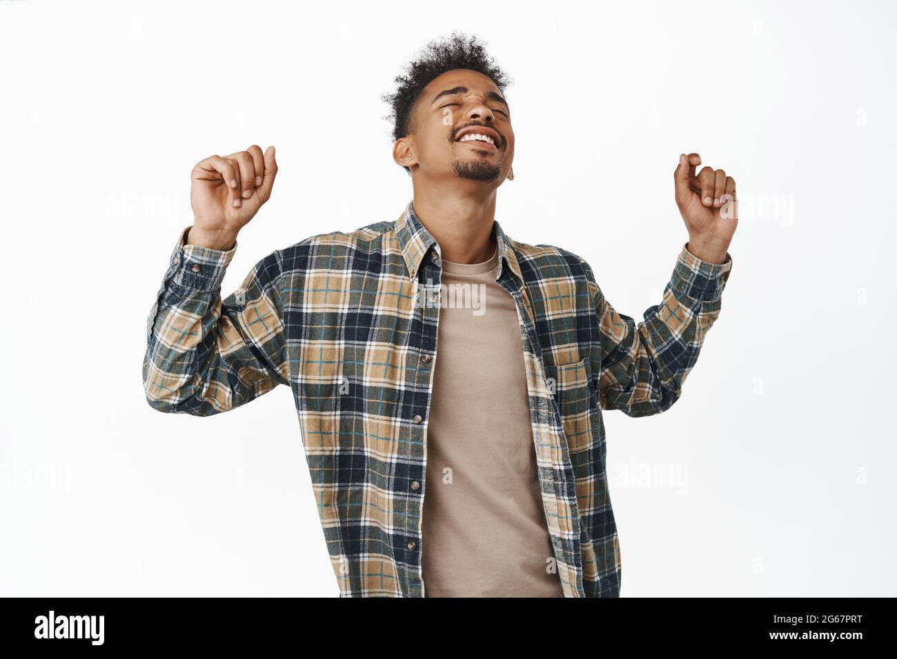 Happy african american man dancing and enjoying party, raising hands up ...