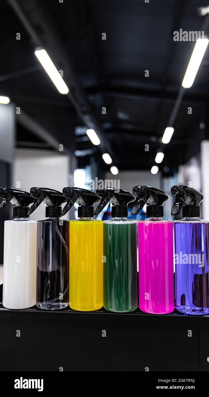 Colorful spray bottles with different chemical liquids Stock Photo - Alamy