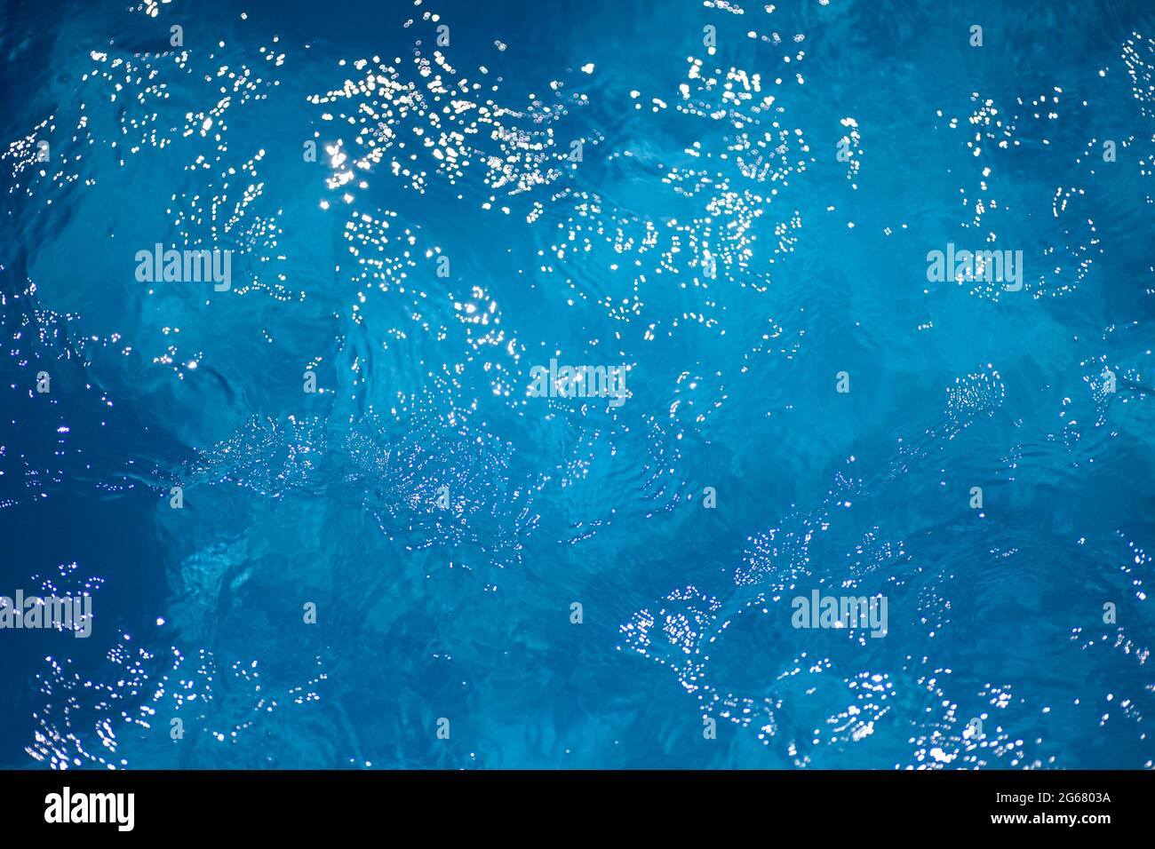 a small ripple on the surface of clear blue sea water, a natural ...