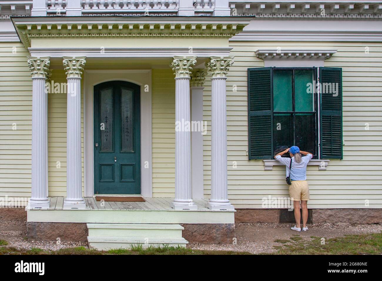A woman looks in the window of the Edward Penniman House, an historic ...