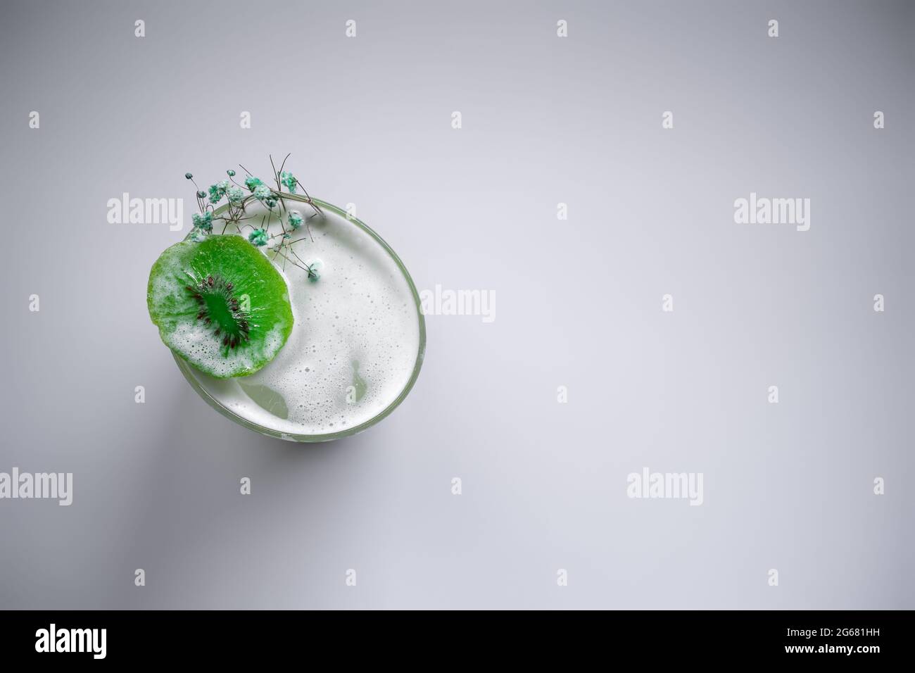 fresh green kiwi kick alcohol cocktail drink in wineglass on white ...