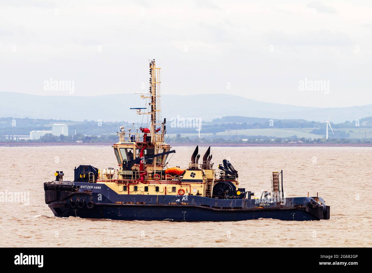 Tugs heading out to sea Stock Photo - Alamy