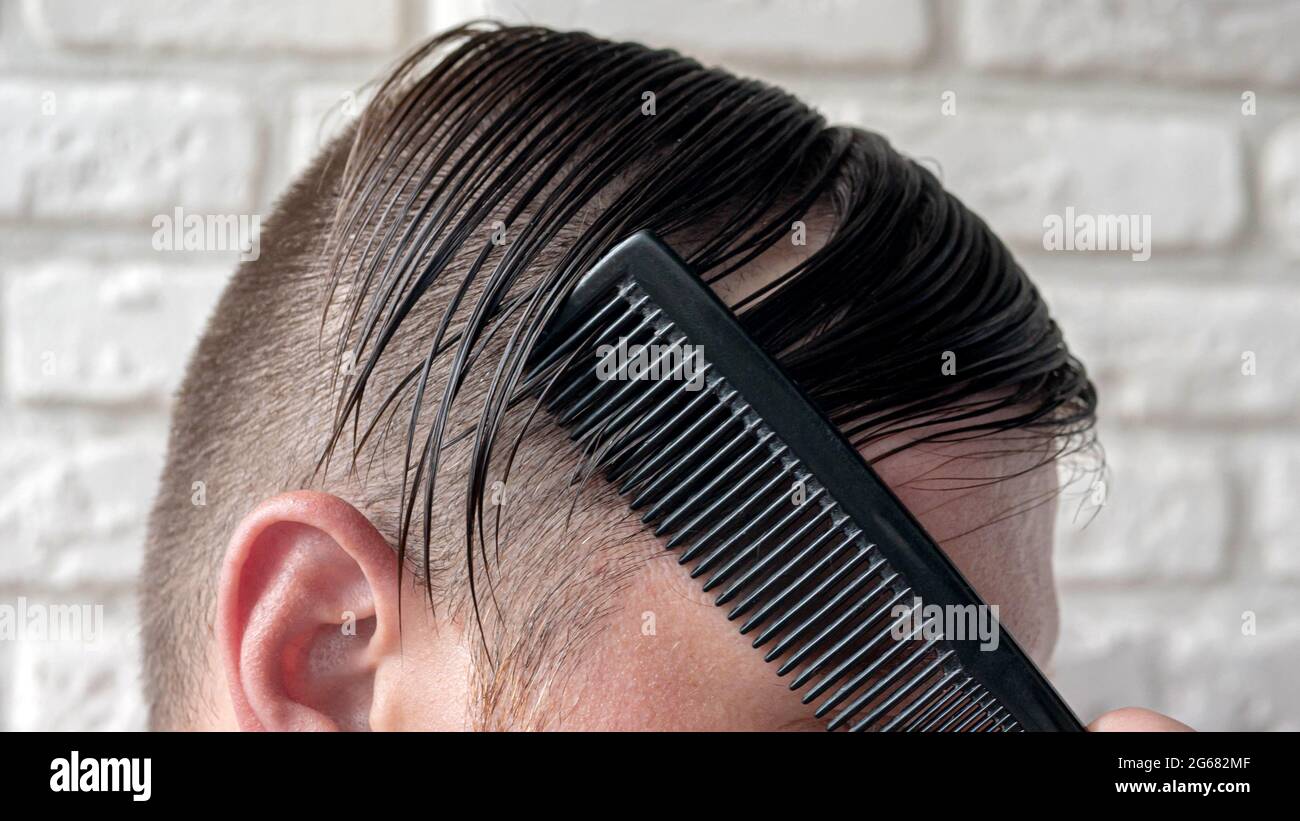 Male hair close up, barbershop. Men's haircut in progress Stock Photo ...