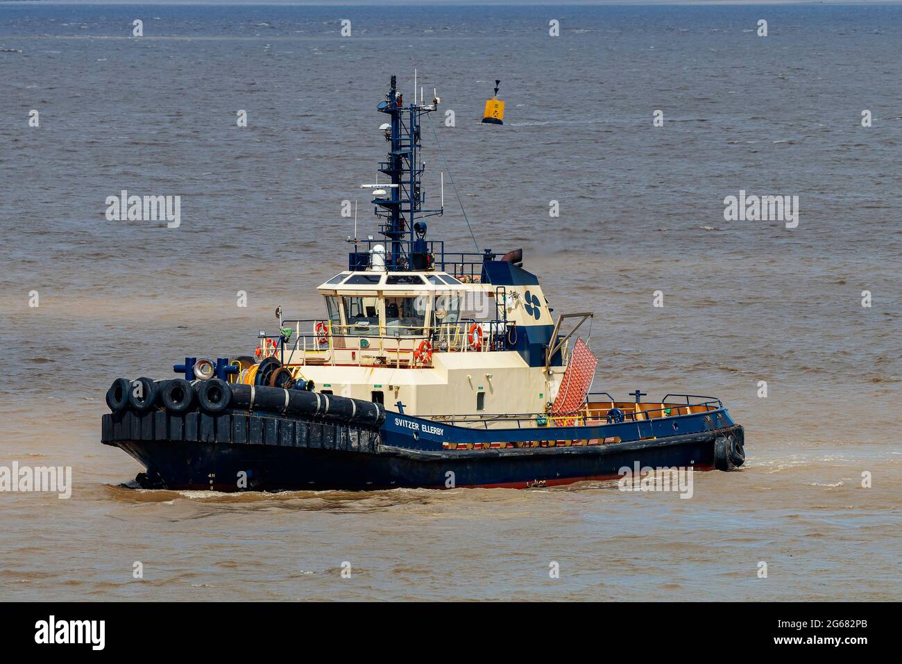 Tugs heading out to sea Stock Photo - Alamy