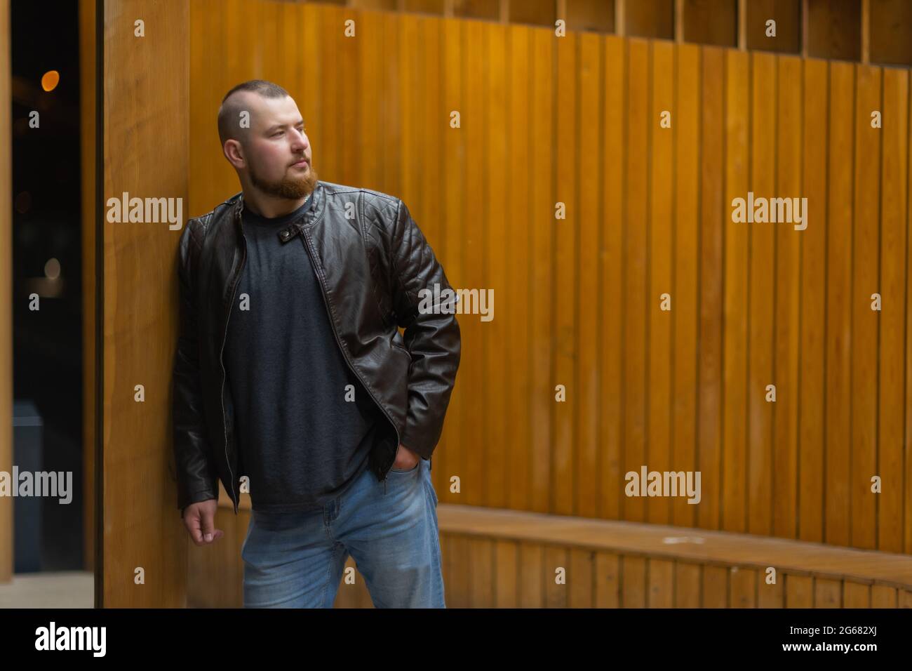 a man stands at a bus stop at night Stock Photo - Alamy