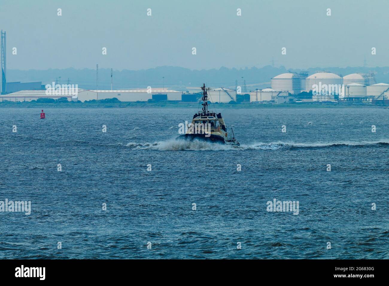 Tugs heading out to sea Stock Photo - Alamy