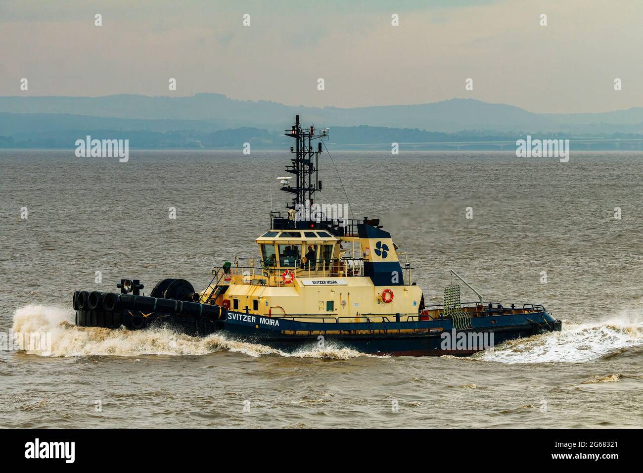 Tugs heading out to sea Stock Photo - Alamy
