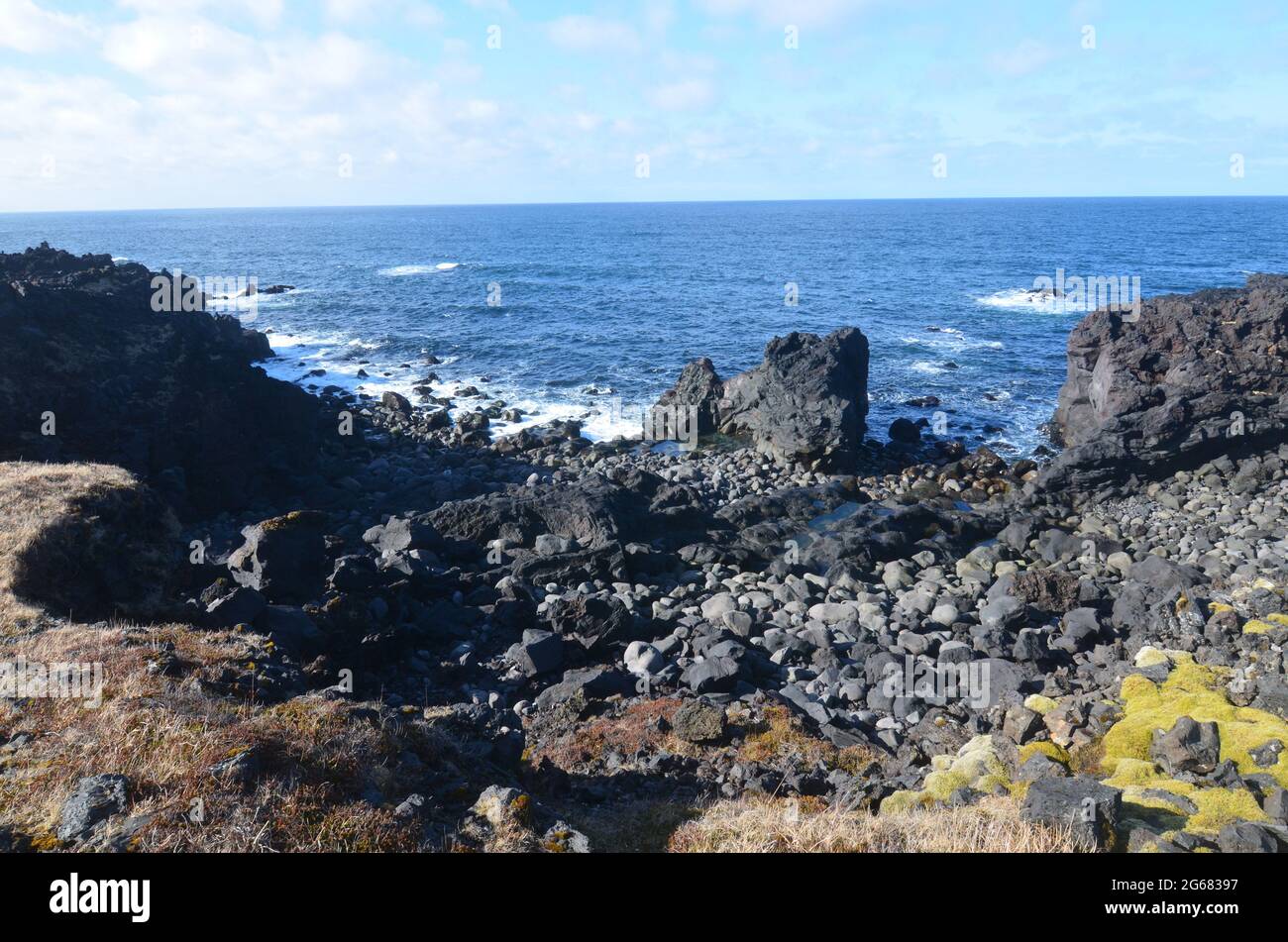 Scenic black lava rock beach in coastal Iceland Stock Photo - Alamy