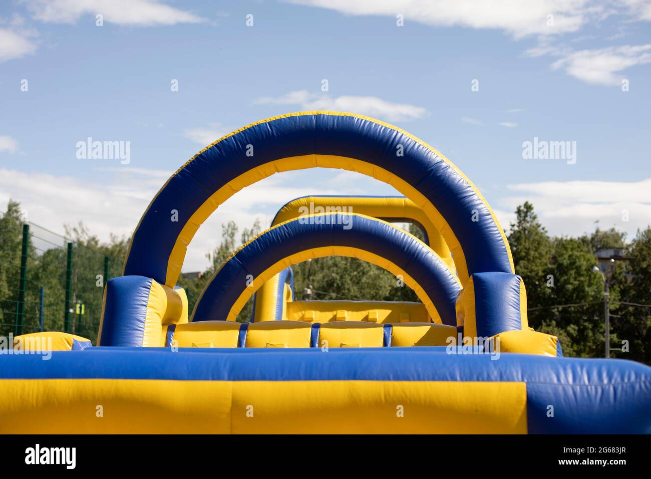 Inflatable obstacle course for fun. Inflatable structure in the park. A ...