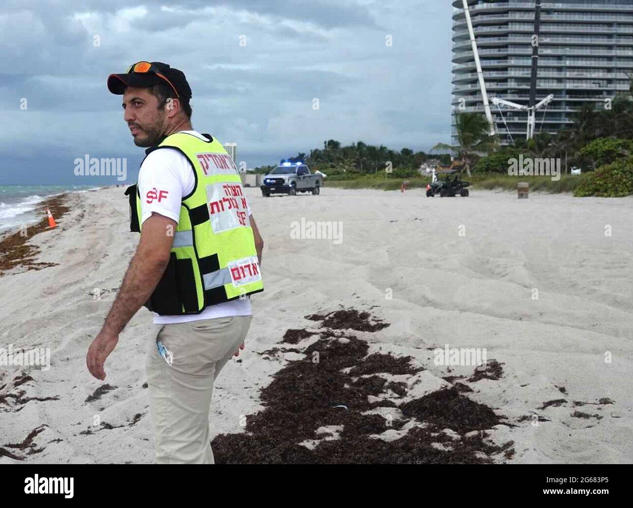 Rescuers Without Borders member Dvir Dimri walks past barriers on beach ...
