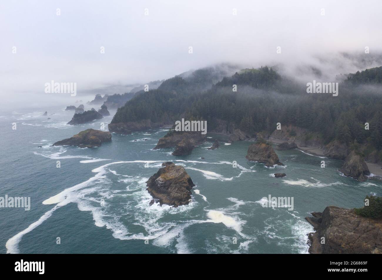 The cold Pacific Ocean washes against the scenic, rugged coastline of ...