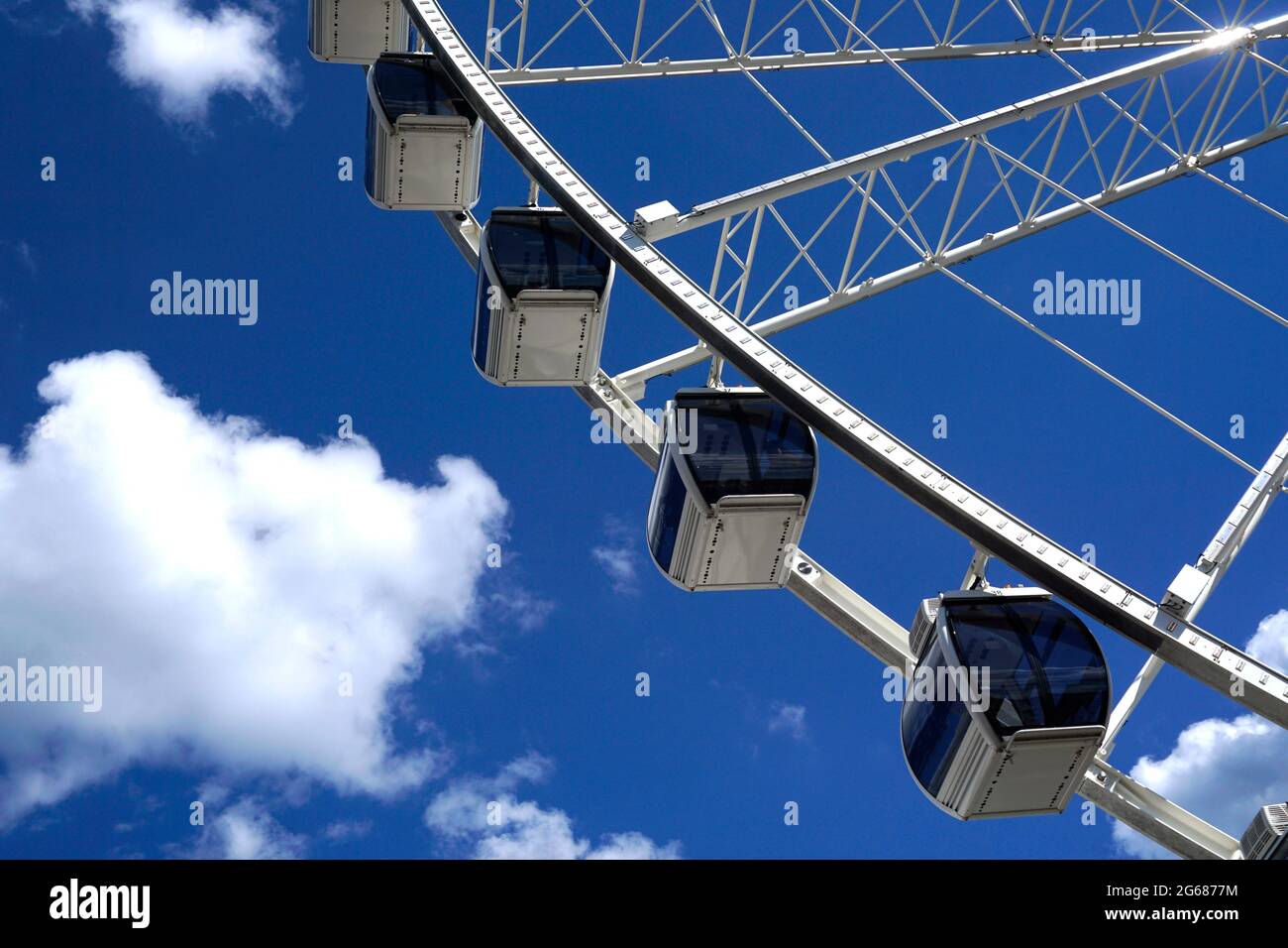 Close-up of a Ferris Wheel against a blue sky with white clouds Stock ...