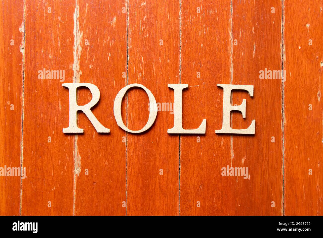 Alphabet letter in word role on old red color wood plate background ...