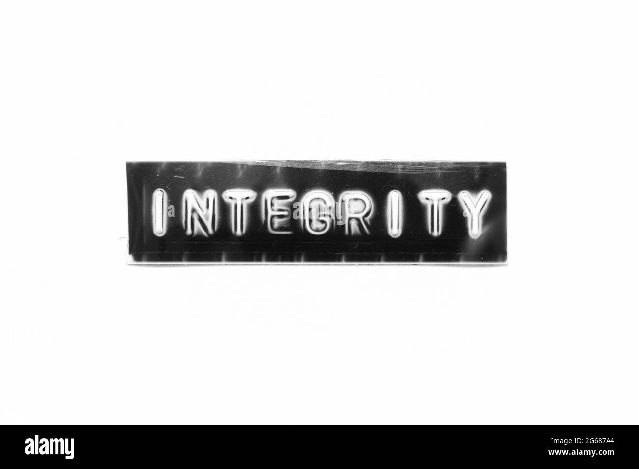 Embossed letter with word integrity in black banner on white paper ...