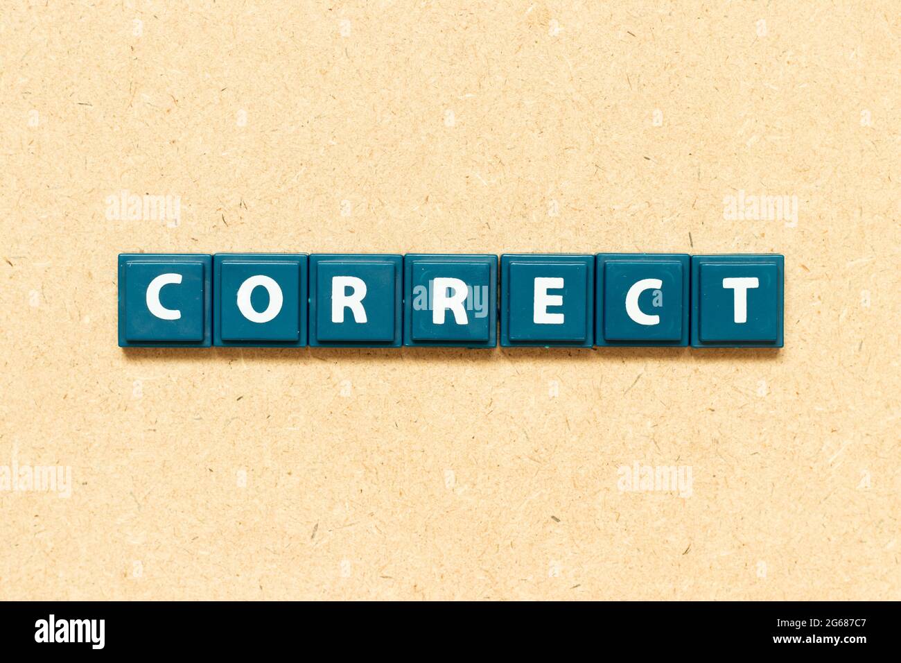 Tile alphabet letter in word correct on wood background Stock Photo - Alamy