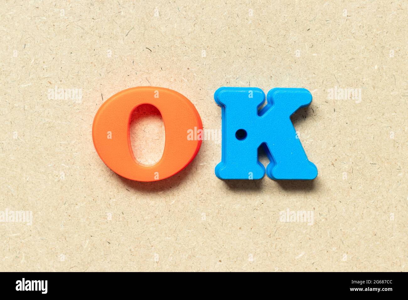 Plastic alphabet letter in word OK on wood background Stock Photo - Alamy