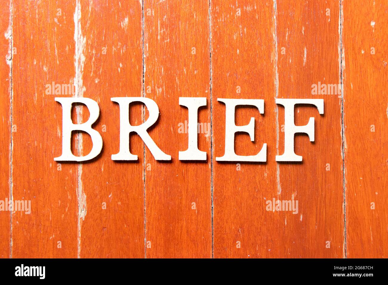 Alphabet letter in word brief on old red color wood plate background ...