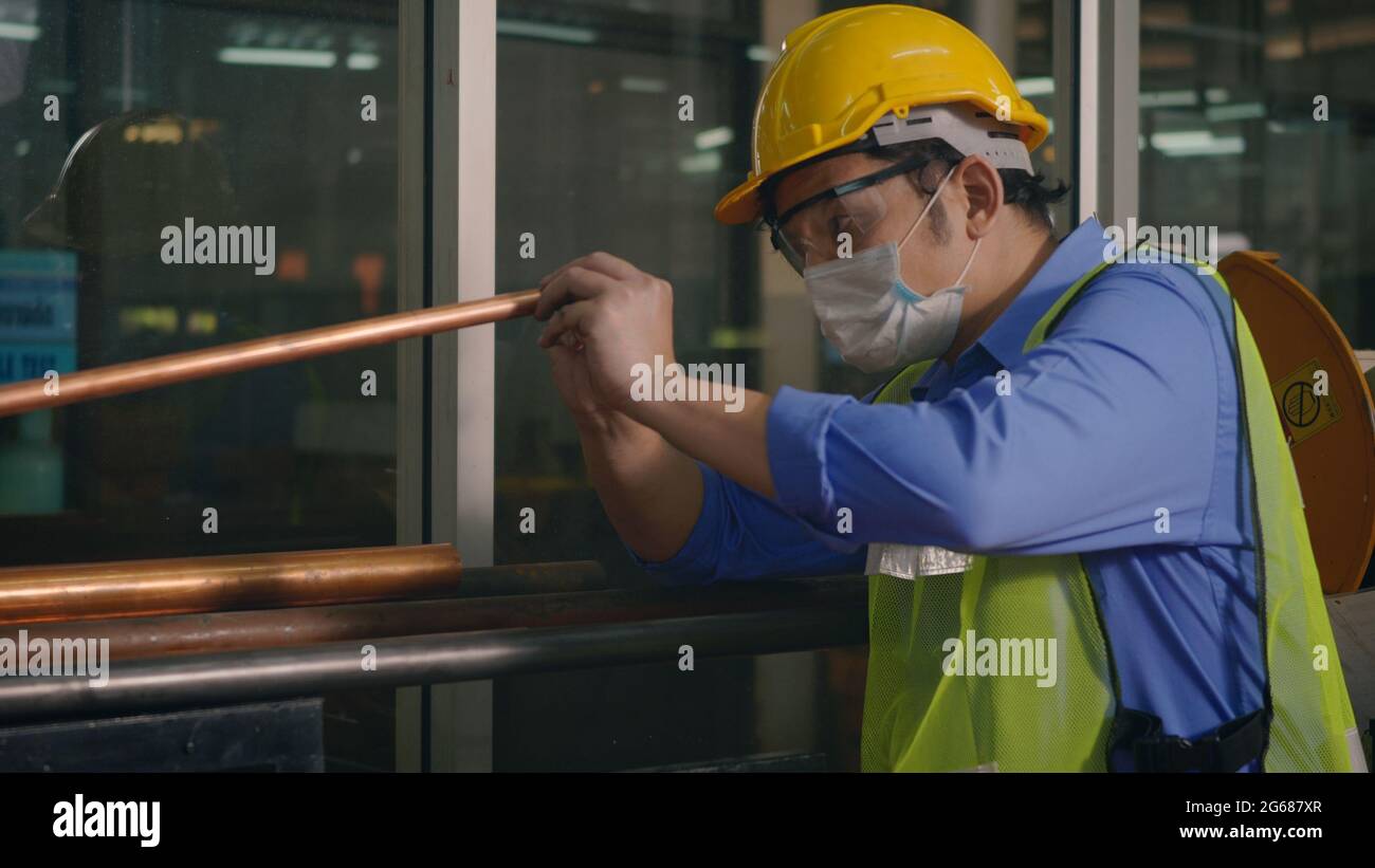 Asian factory worker man technician or engineering wearing protective ...