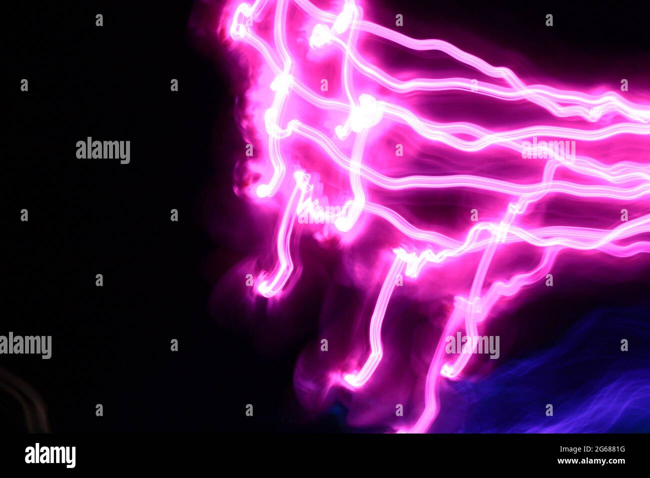 Sparkling intersecting light paths with festive lighting at night. Long ...