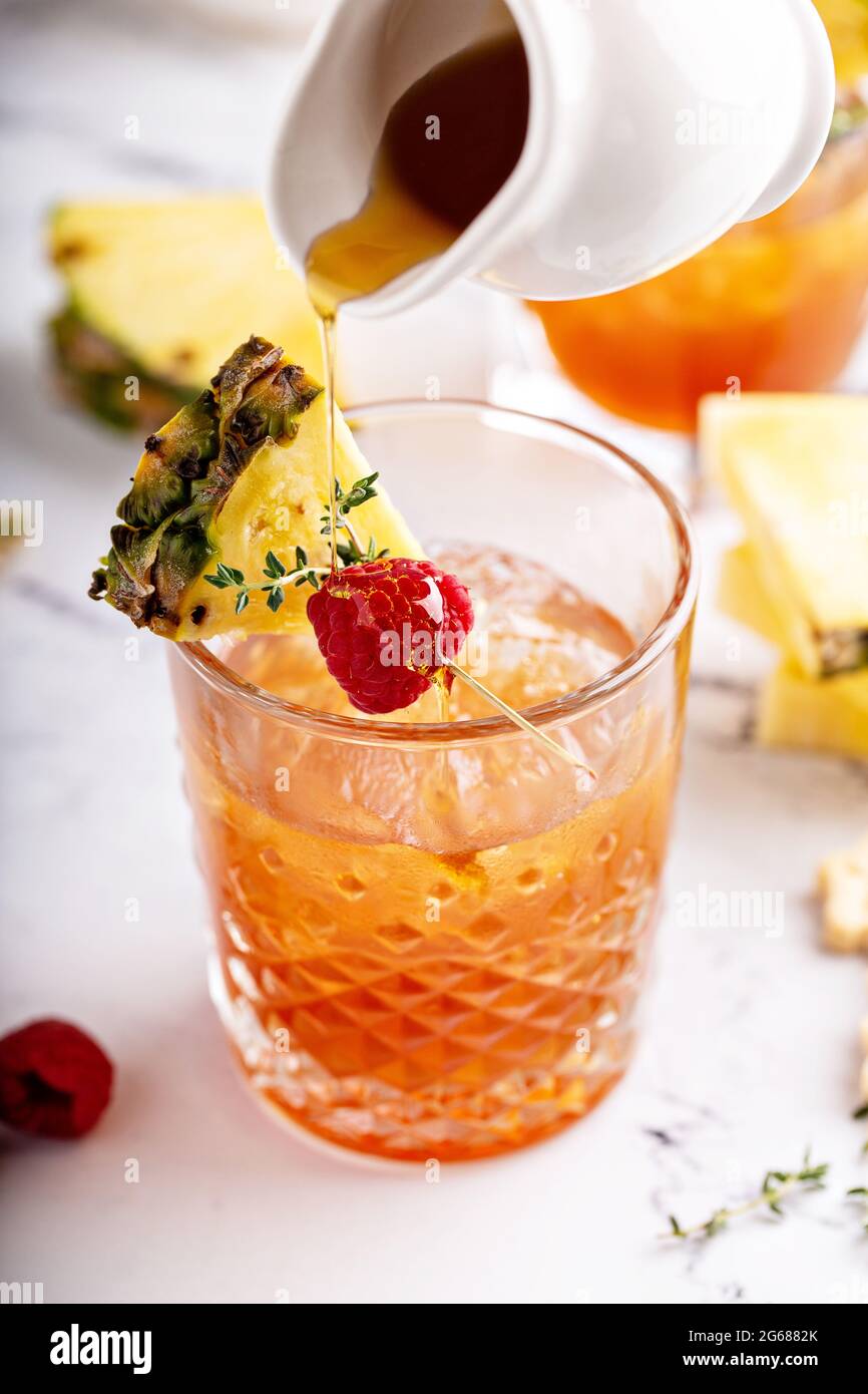 Pineapple, raspberry and honey cocktail or mocktail Stock Photo - Alamy